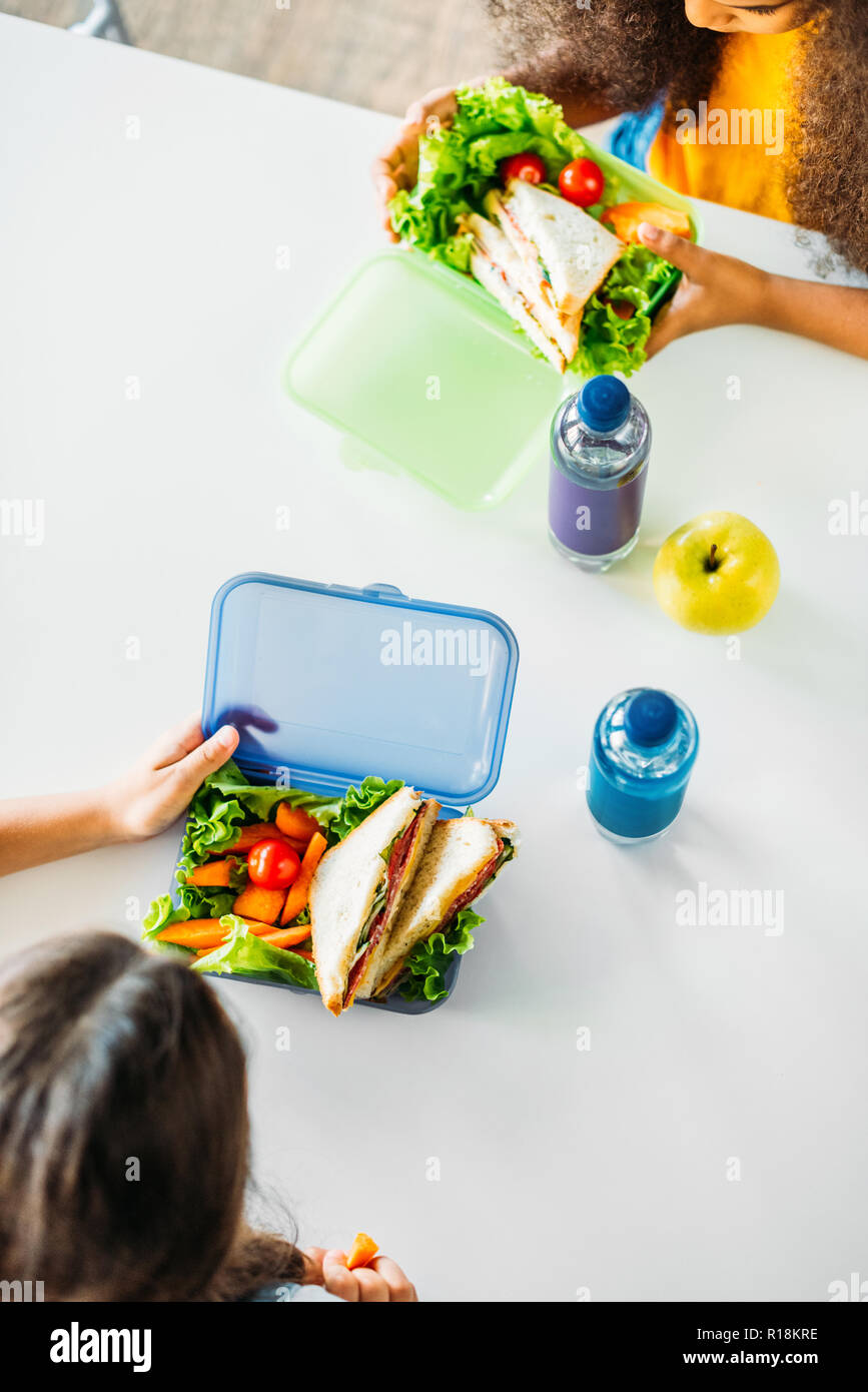 top view of little schoolgirls taking lunch together Stock Photo - Alamy