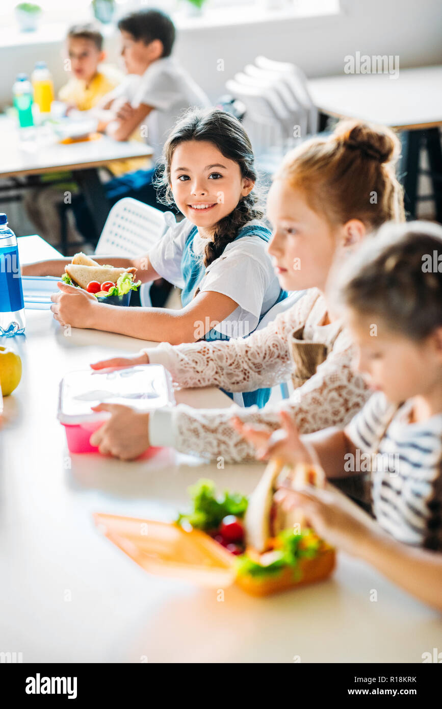 little happy schoolgirls taking lunch at school cafeteria Stock Photo ...