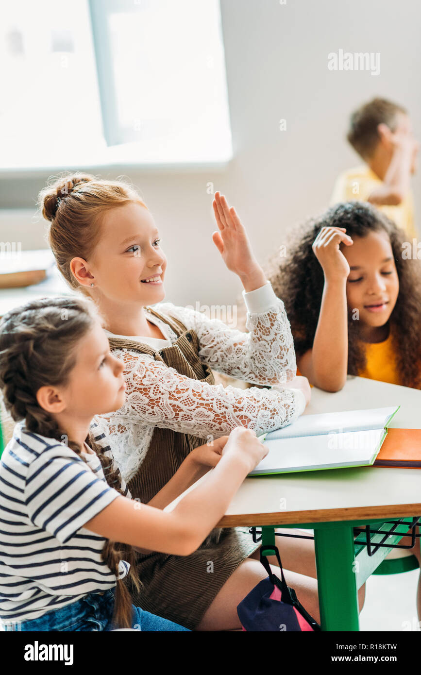 Kids raising hands classroom hi-res stock photography and images - Alamy