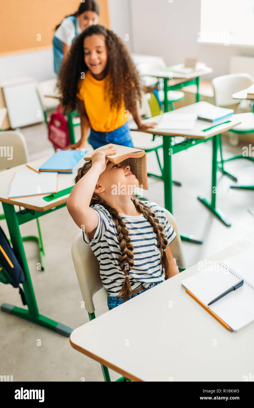 adorable happy schoolchildren relaxing at classroom during break Stock ...