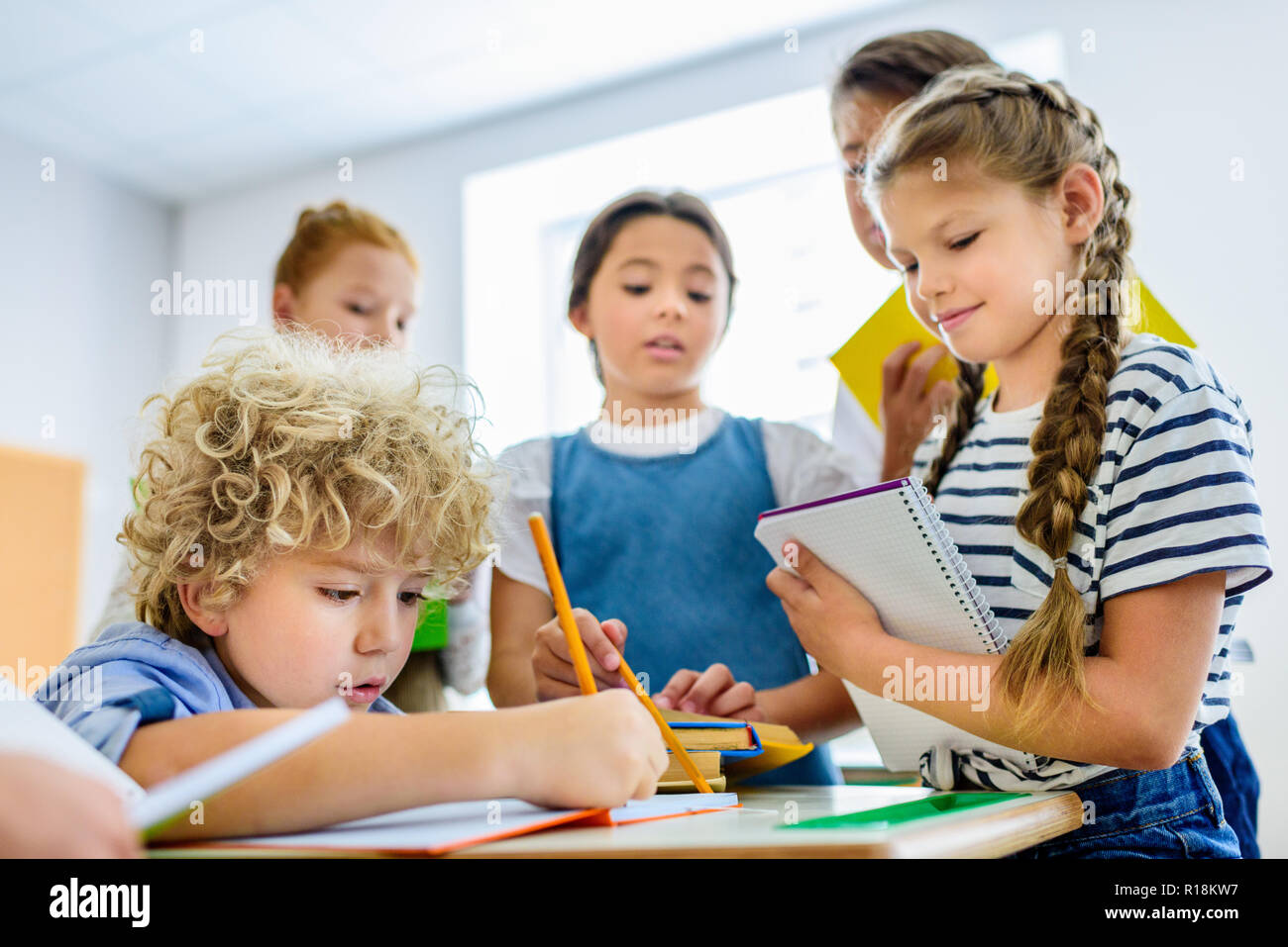 pupils writing off homework of their classmate during break Stock Photo ...