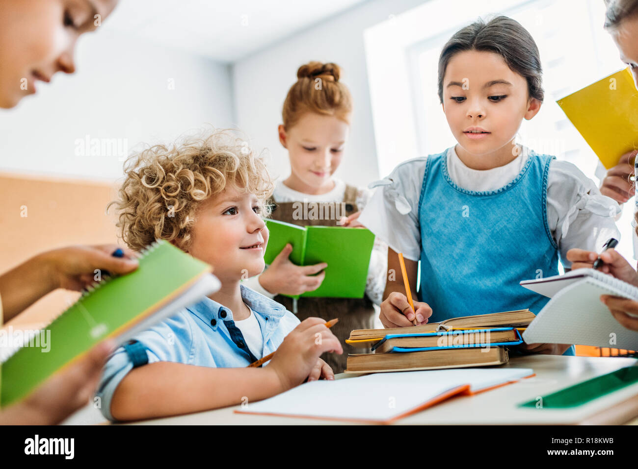 schoolchildren writing off homework of their classmate during break ...