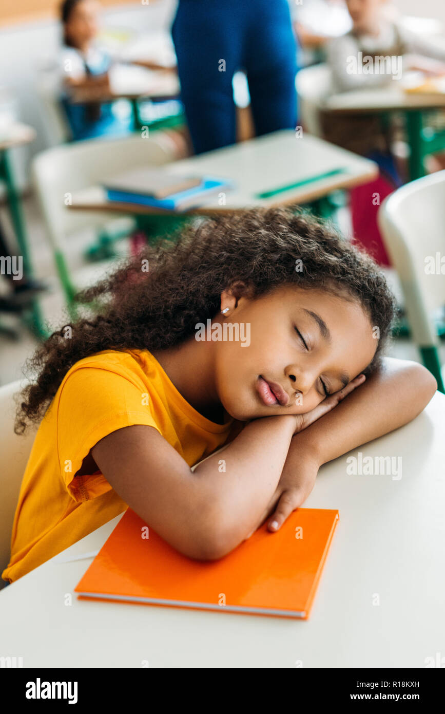 tired african american schoolgirl sleeping on desk during lesson Stock ... tired african american schoolgirl sleeping on desk during lesson Stock ...