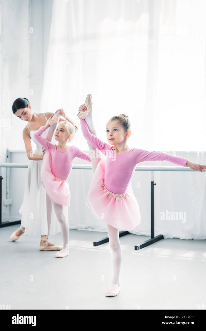ballet teacher exercising with small dancers in ballet school Stock ...