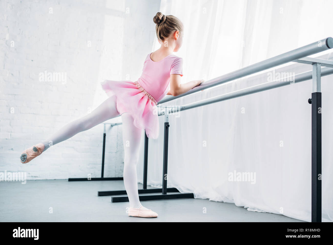 cute little ballerina in pink tutu practicing in ballet studio Stock ...