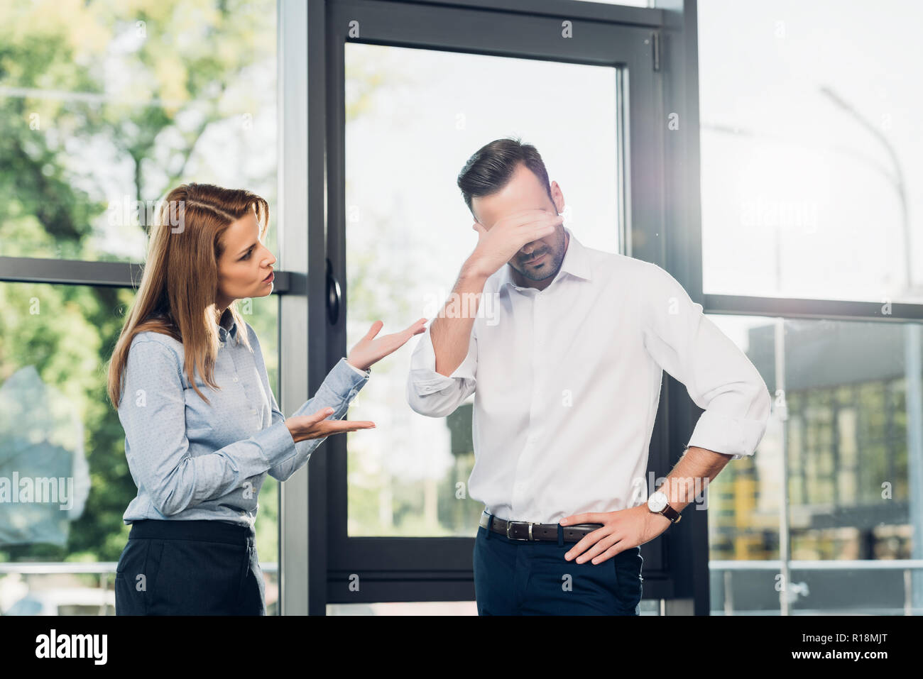 business colleagues having conversation in conference hall Stock Photo ...