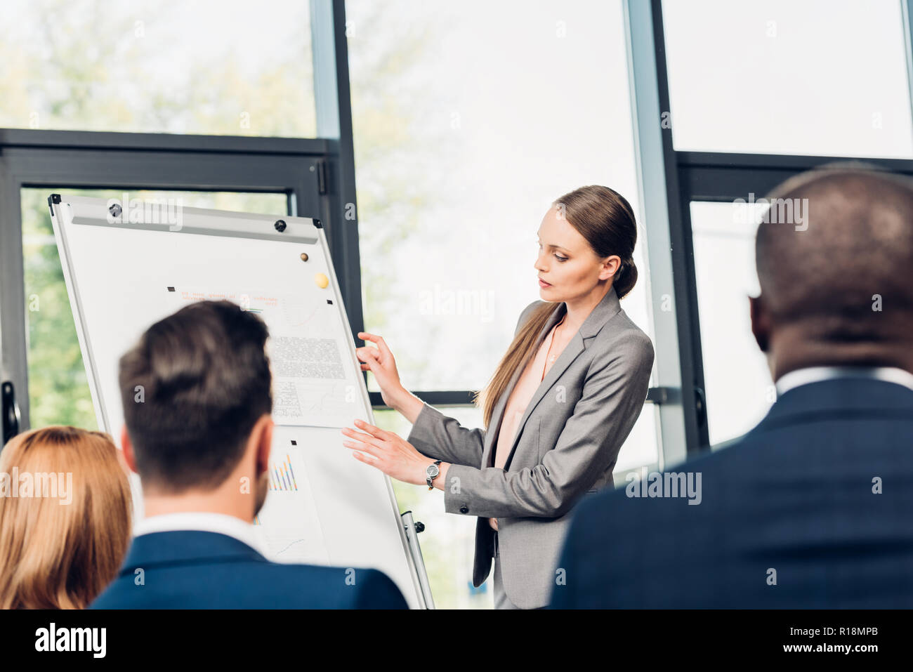 female business lecturer presenting material during seminar with ...