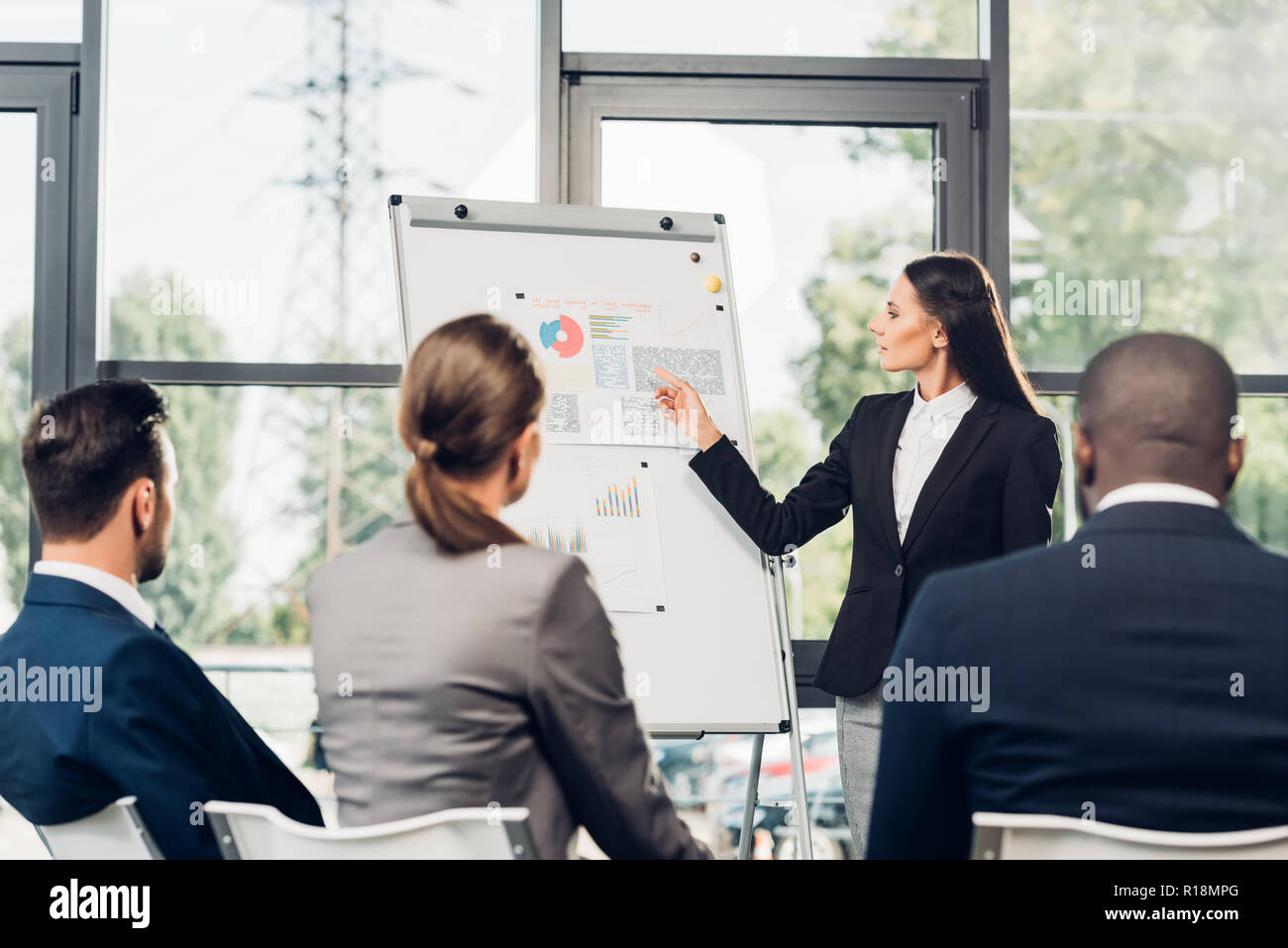 female business lecturer presenting material during seminar with ...