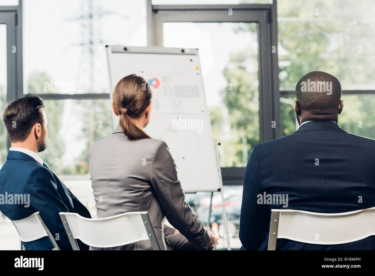 back view of multicultural businesspeople sitting in conference hall ...