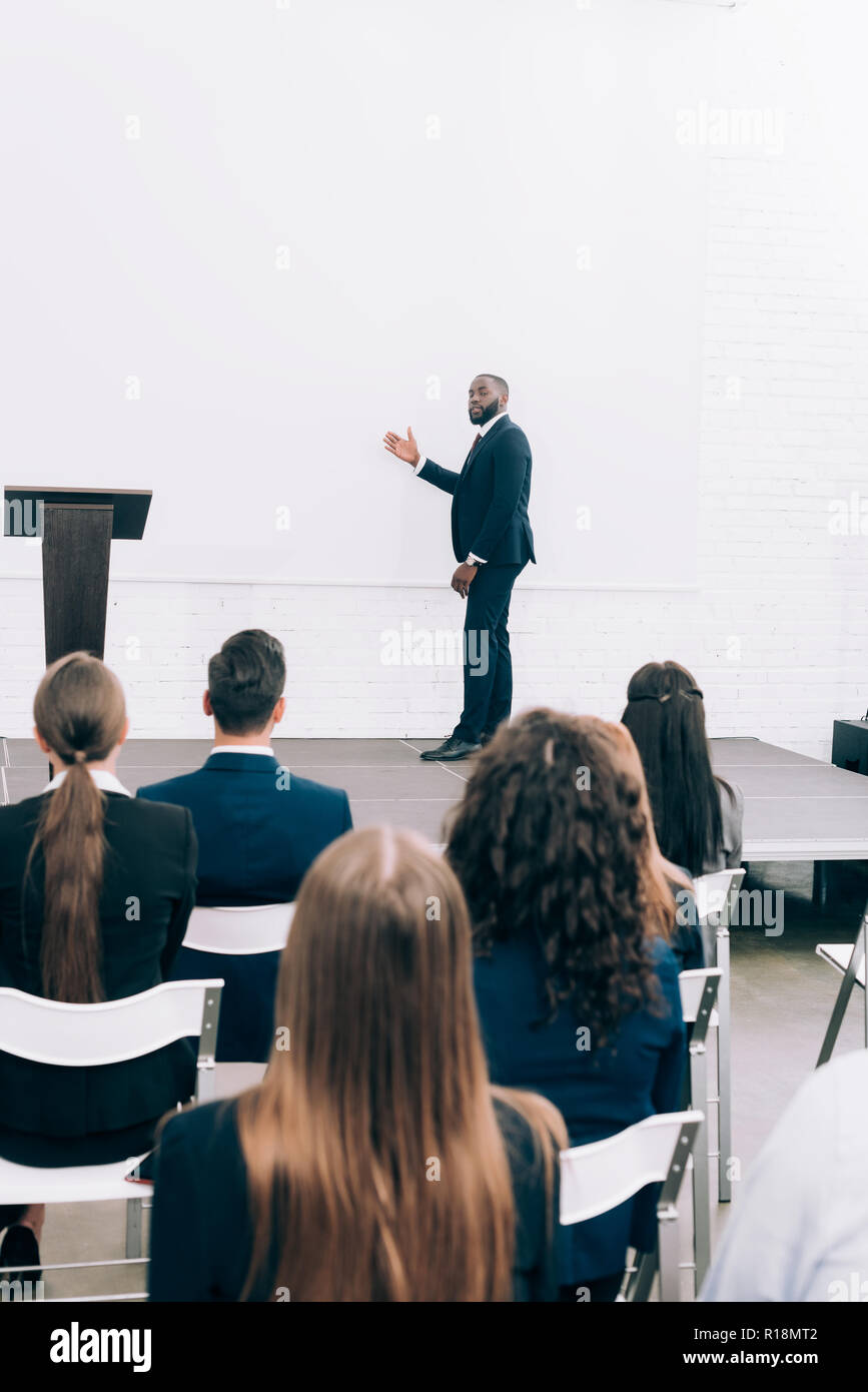 african american lecturer talking to audience during seminar in ...