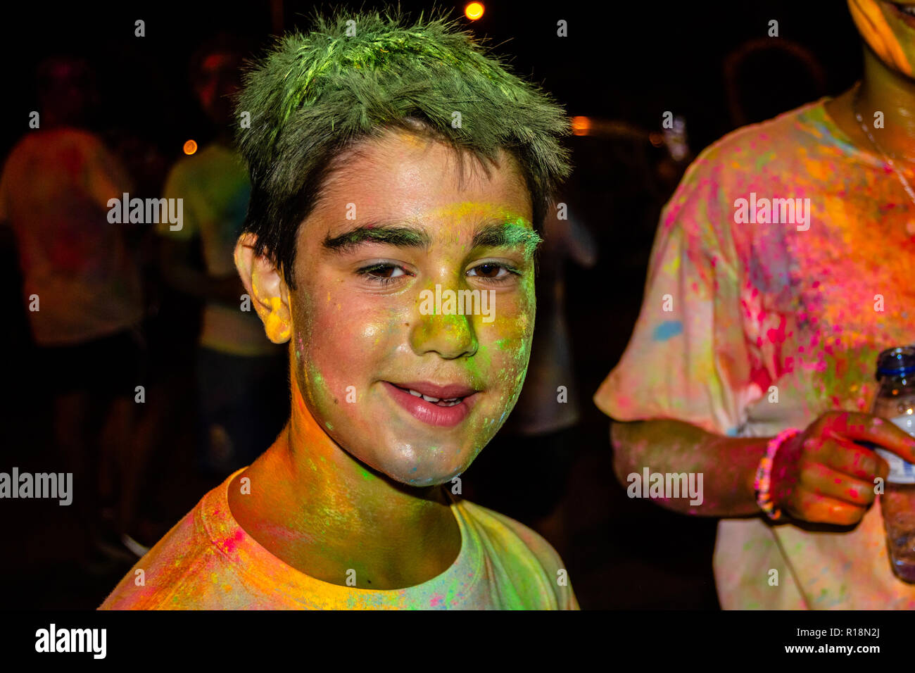 Portrait of teenage boy with paint on his face after a color run Stock ...