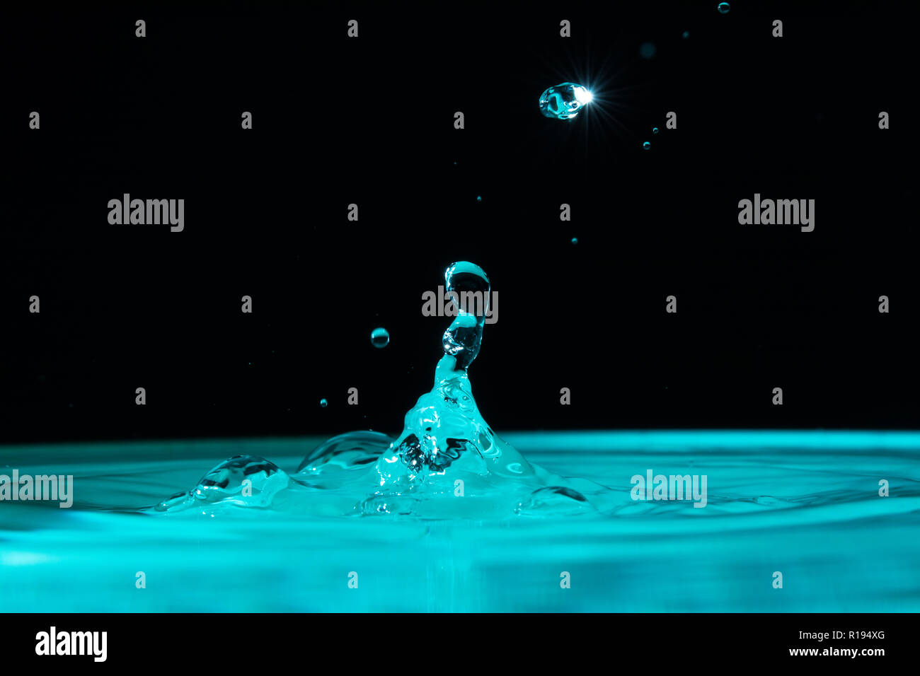 Drops of water macro with a beautiful sun flare in a star shape ...