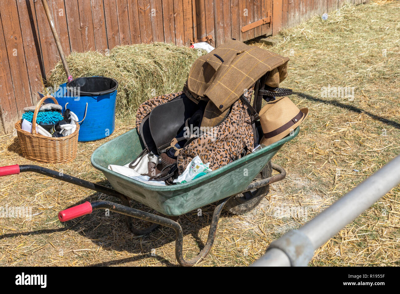 Horses equestrian equipment in a wheelbarrow Stock Photo - Alamy