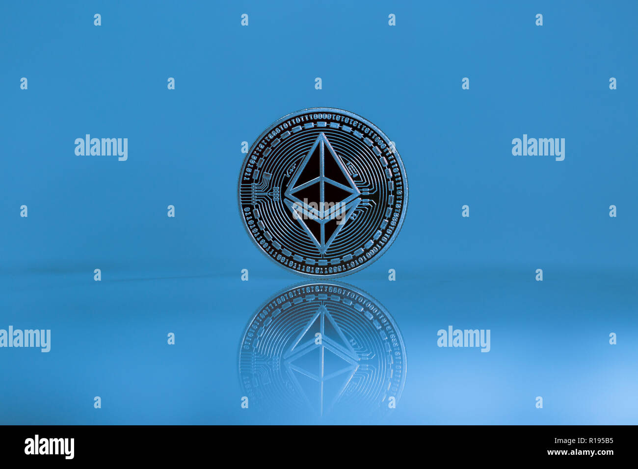 Ethereum Classic physical coin in the blue background Stock Photo - Alamy