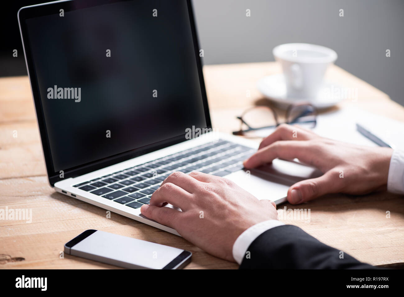 Business man using notebook in a coffe shop. Close up Stock Photo - Alamy