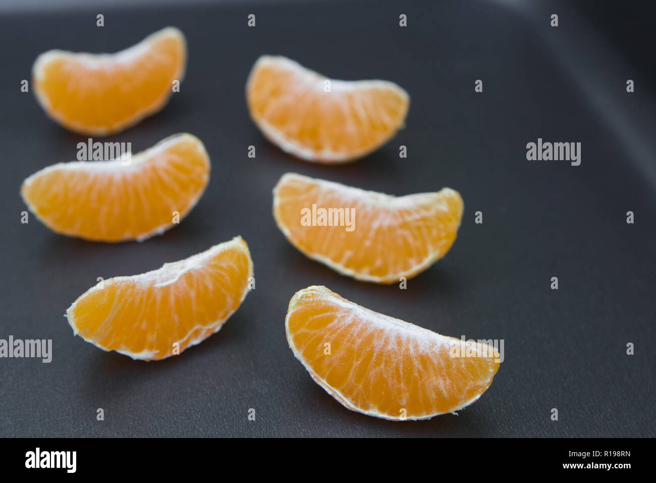 six bright orange color mandarin slices top view isolated on grey ...