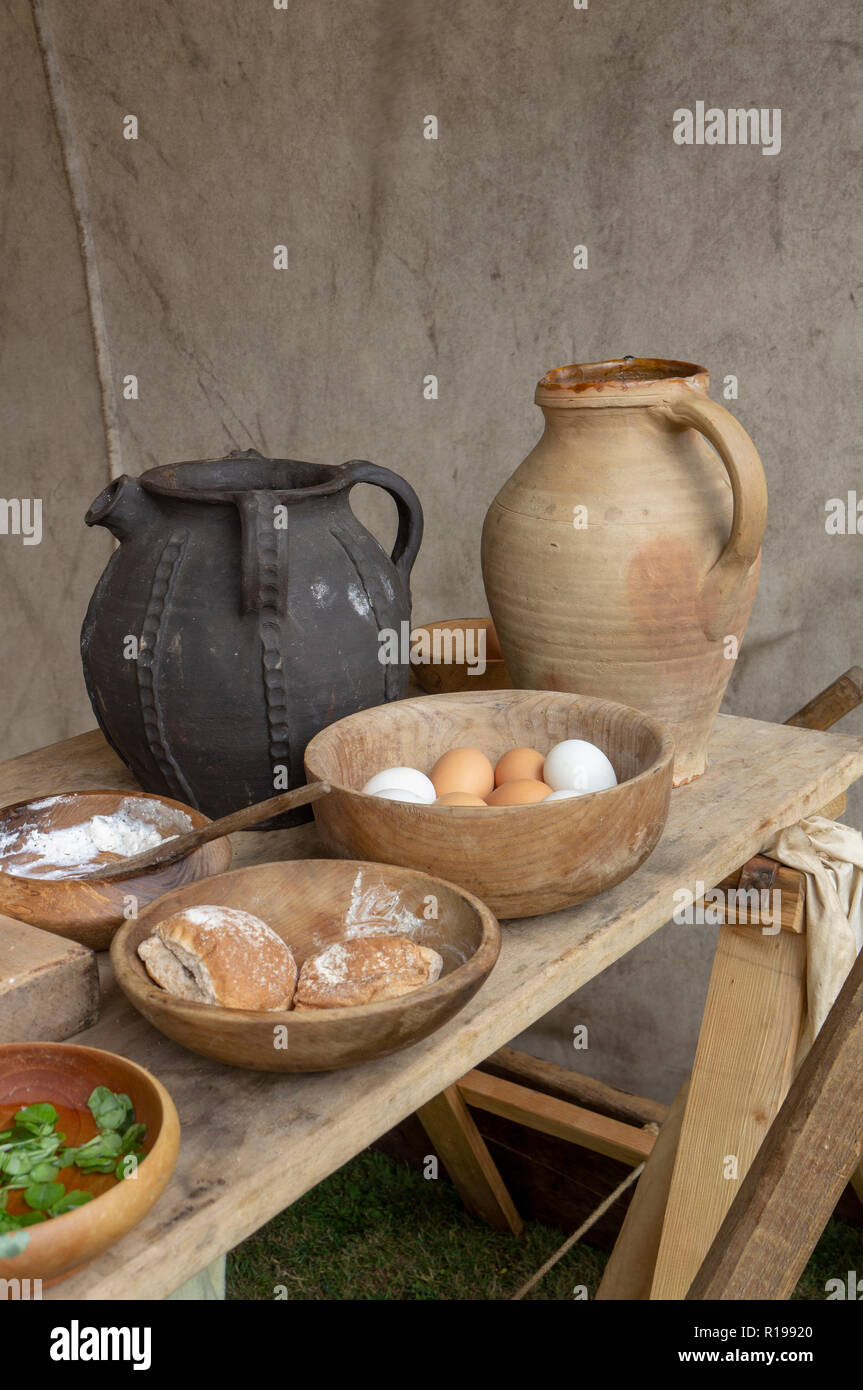 Early medieval beer jugs and wooden bowls full of eggs and other ...