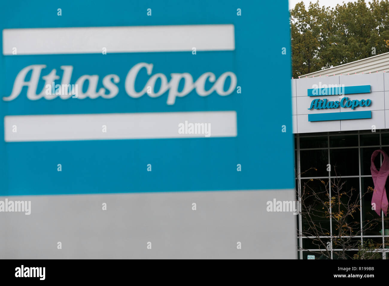 A logo sign outside of a facility occupied by Atlas Copco in Auburn ...