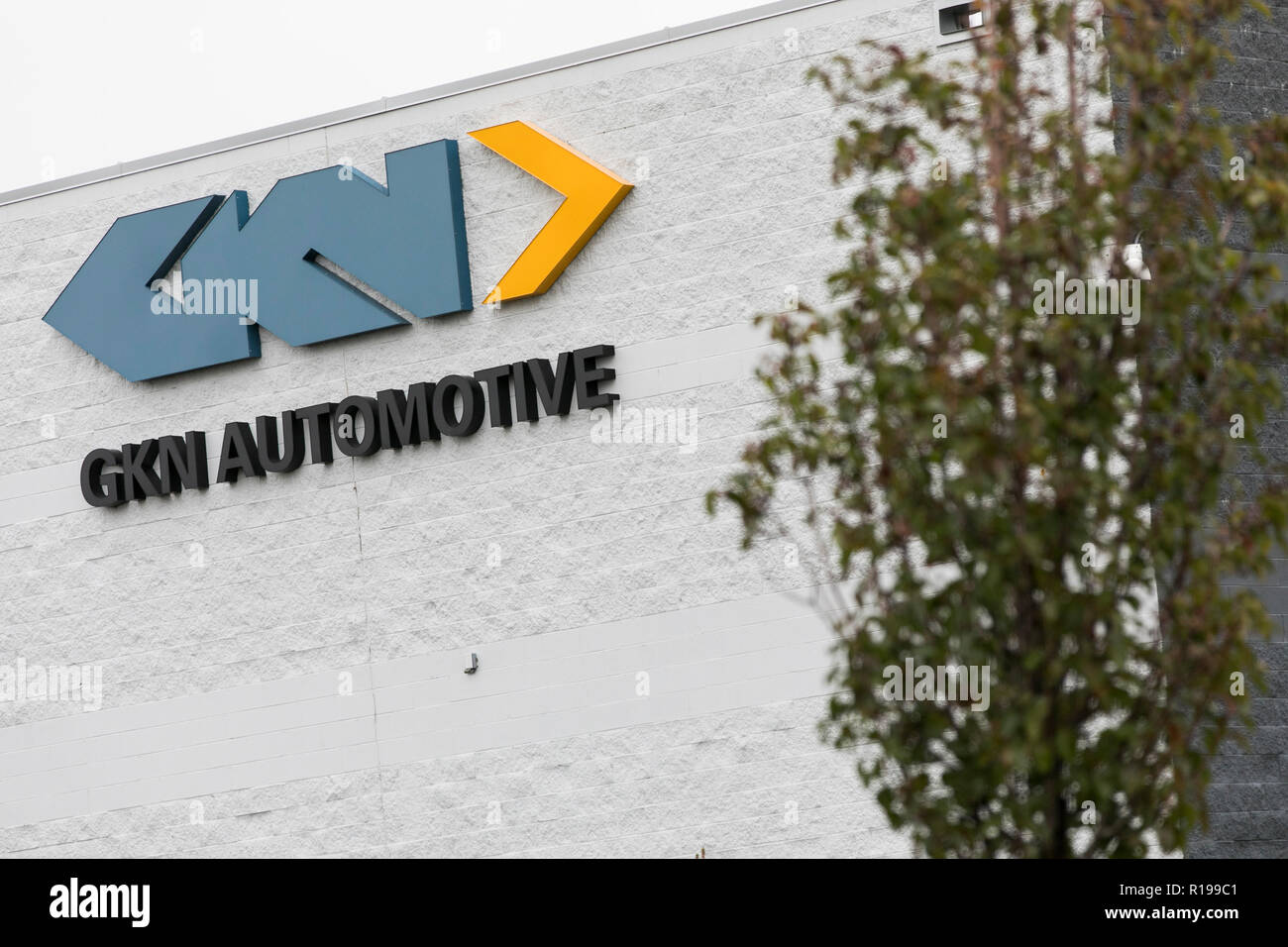 A logo sign outside of a facility occupied by GKN Automotive in Auburn ...