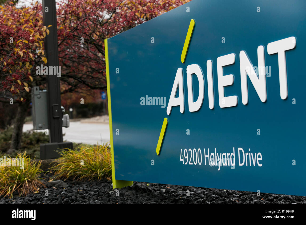 A logo sign outside of a facility occupied by Adient in Plymouth ...