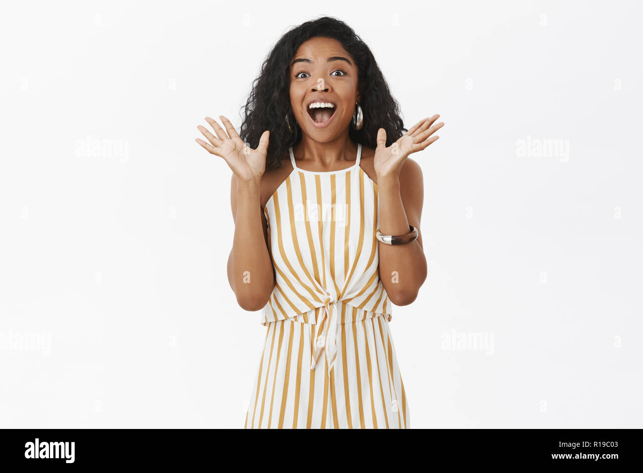Portrait of joyful excited dark-skinned woman telling awesome news ...