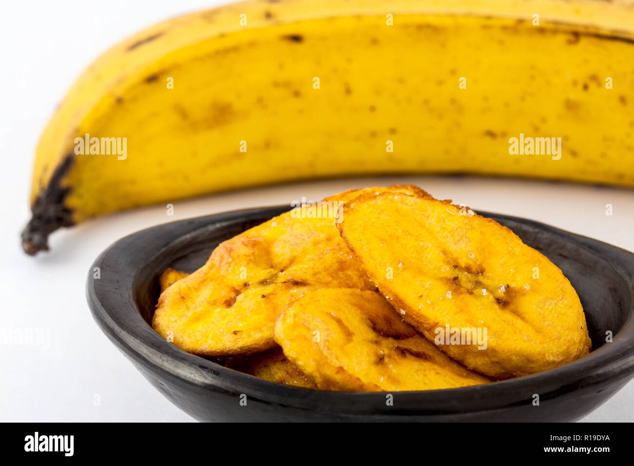 Fried half ripe plantain slices isolated on white background Stock ...