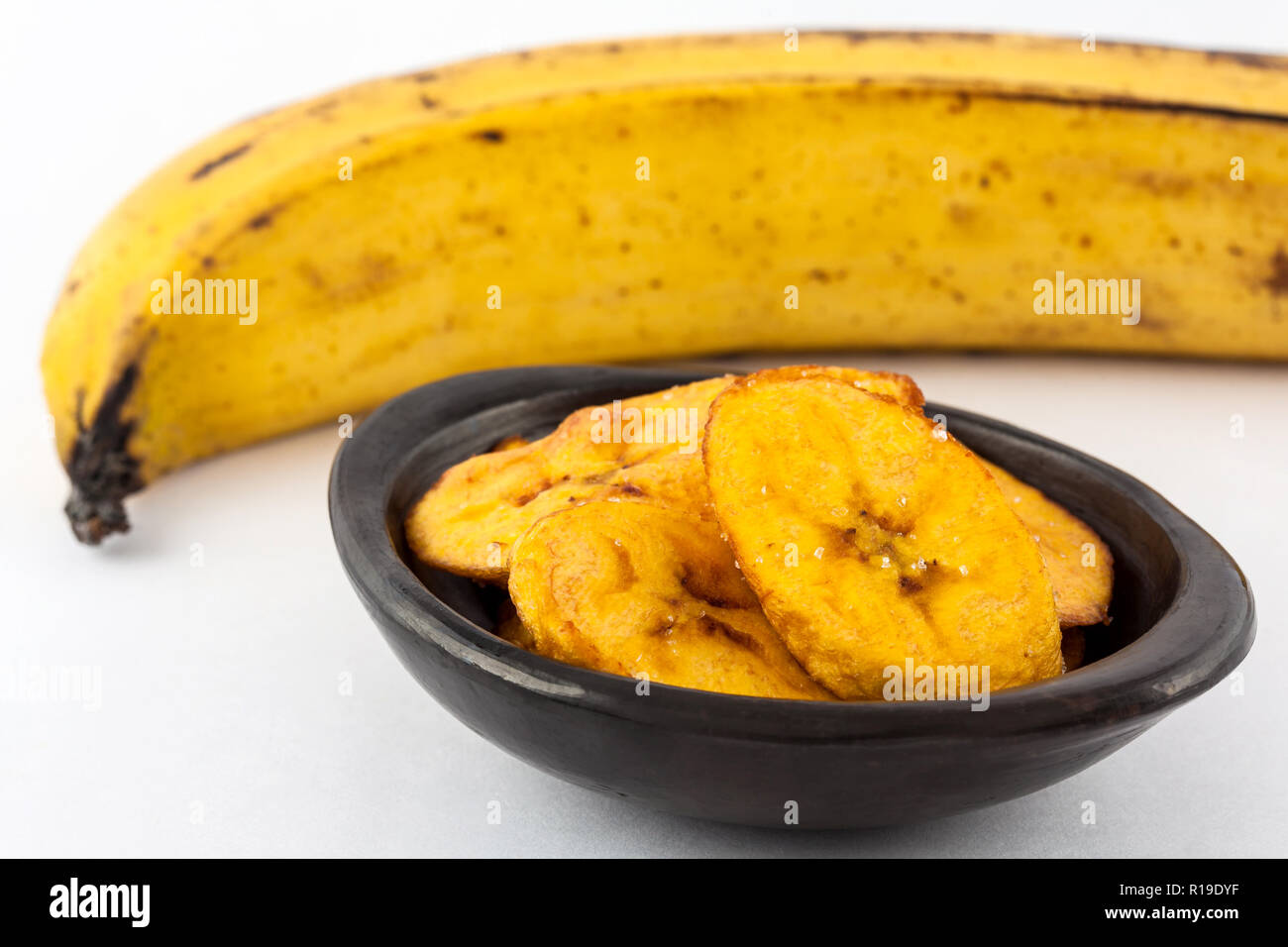 Fried half ripe plantain slices isolated on white background Stock ...