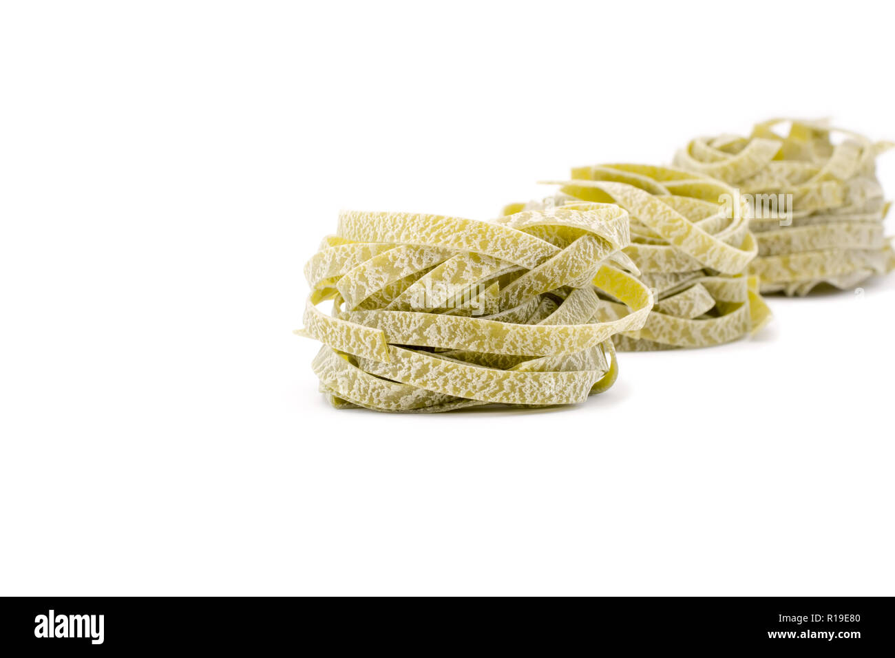 three roll pasta on a white background Stock Photo - Alamy