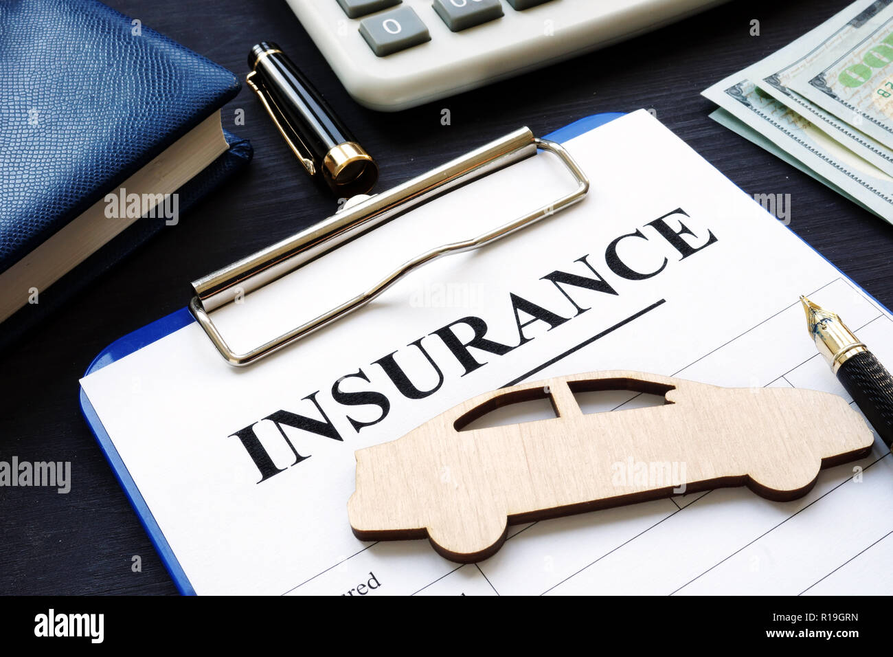 Car insurance. Policy with pen and model Stock Photo - Alamy