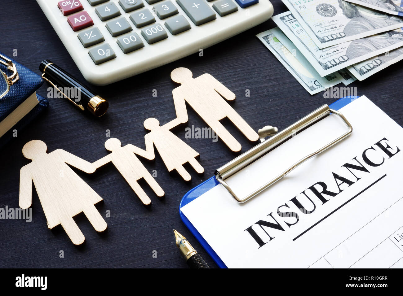 Life insurance. Policy and figures of family Stock Photo - Alamy