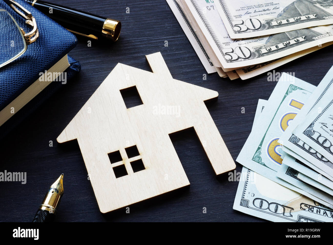 Model of house and money. Real estate investment Stock Photo - Alamy