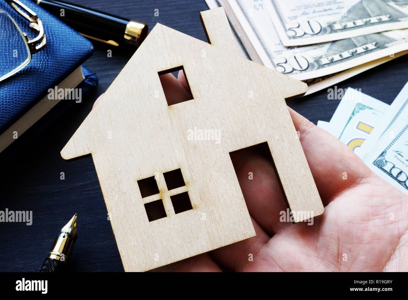 Hand holding model of house. Buying property or mortgage Stock Photo ...