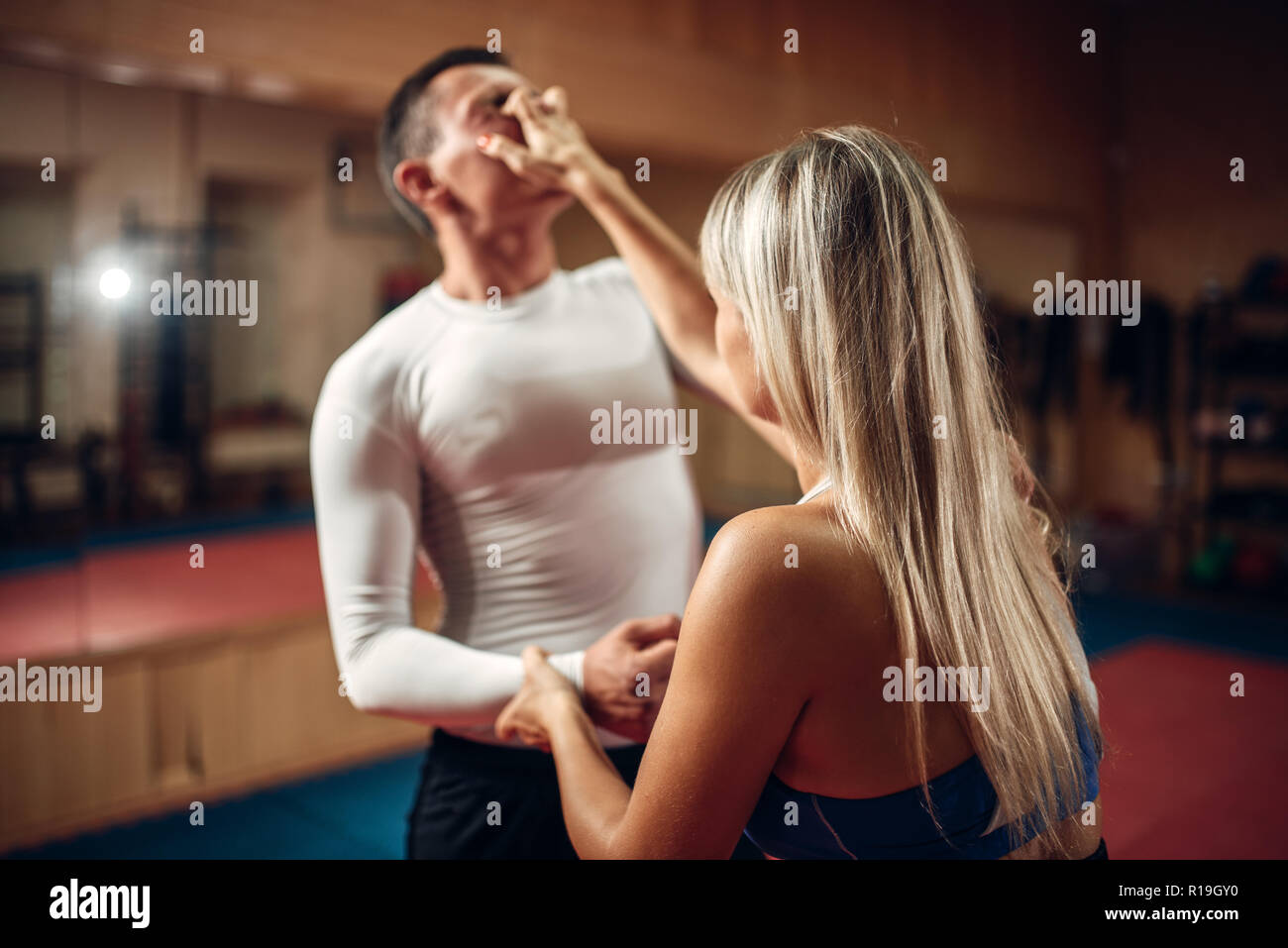 Female person makes pain in the eyes, self-defense workout with male ...