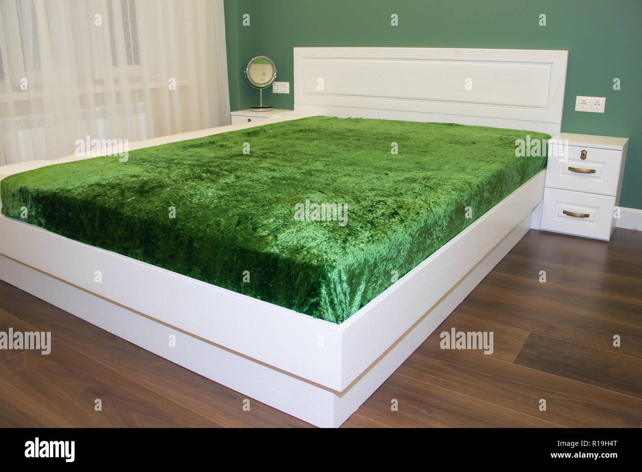 Large white bed in the bedroom. The interior of the bedroom. White ...