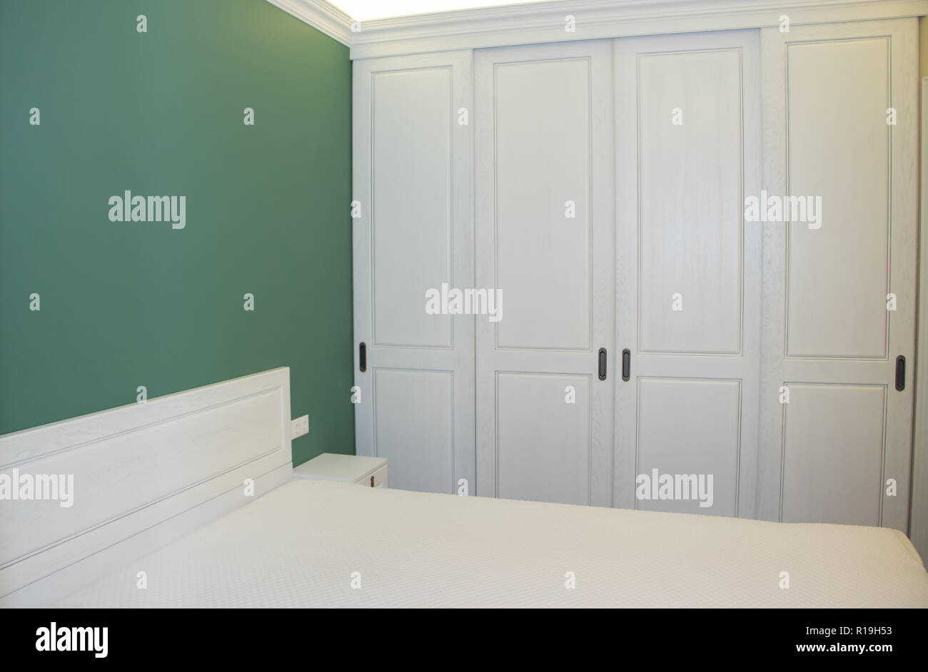 Large white bed in the bedroom. The interior of the bedroom. White ...