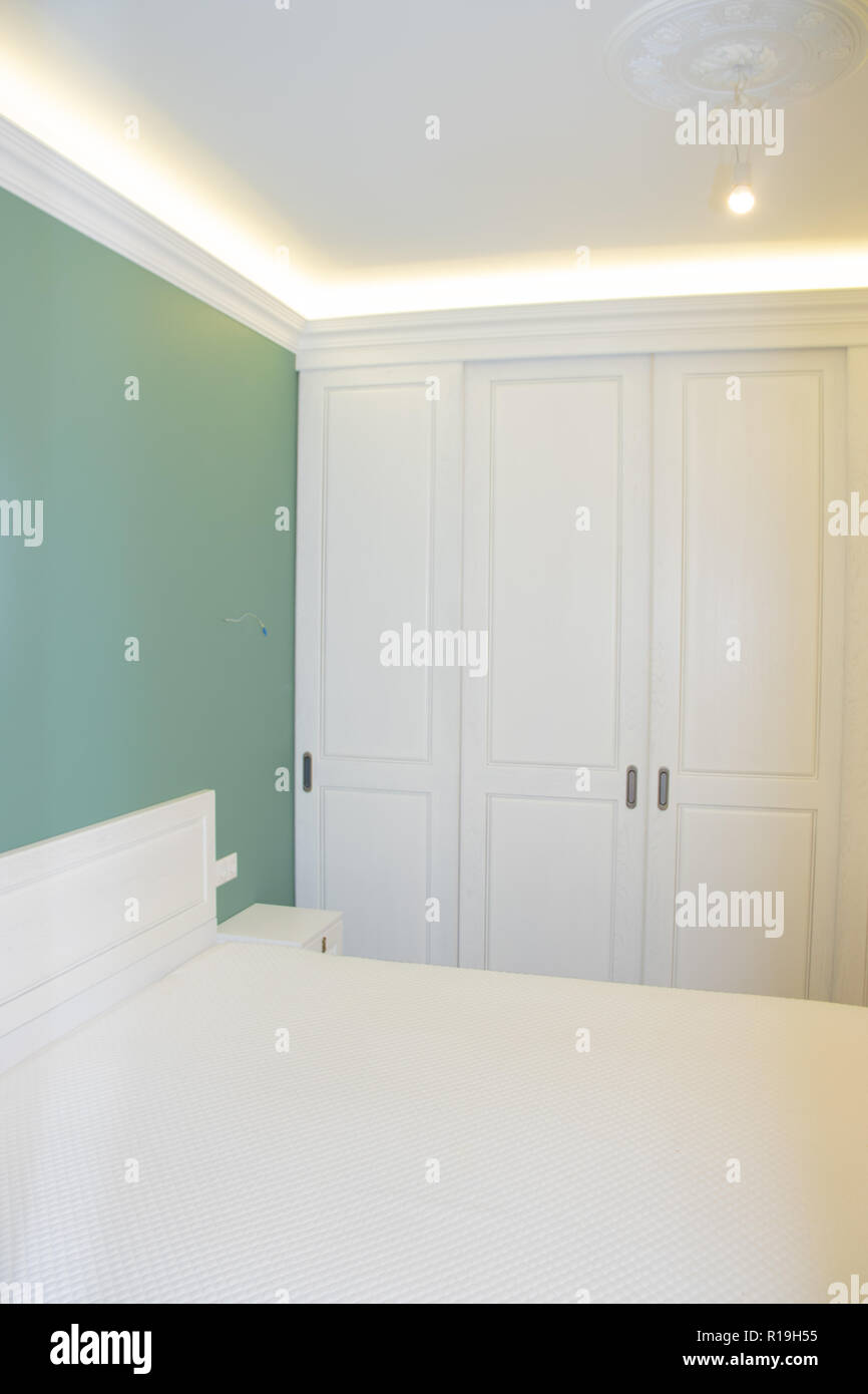 Large white bed in the bedroom. The interior of the bedroom. White ...