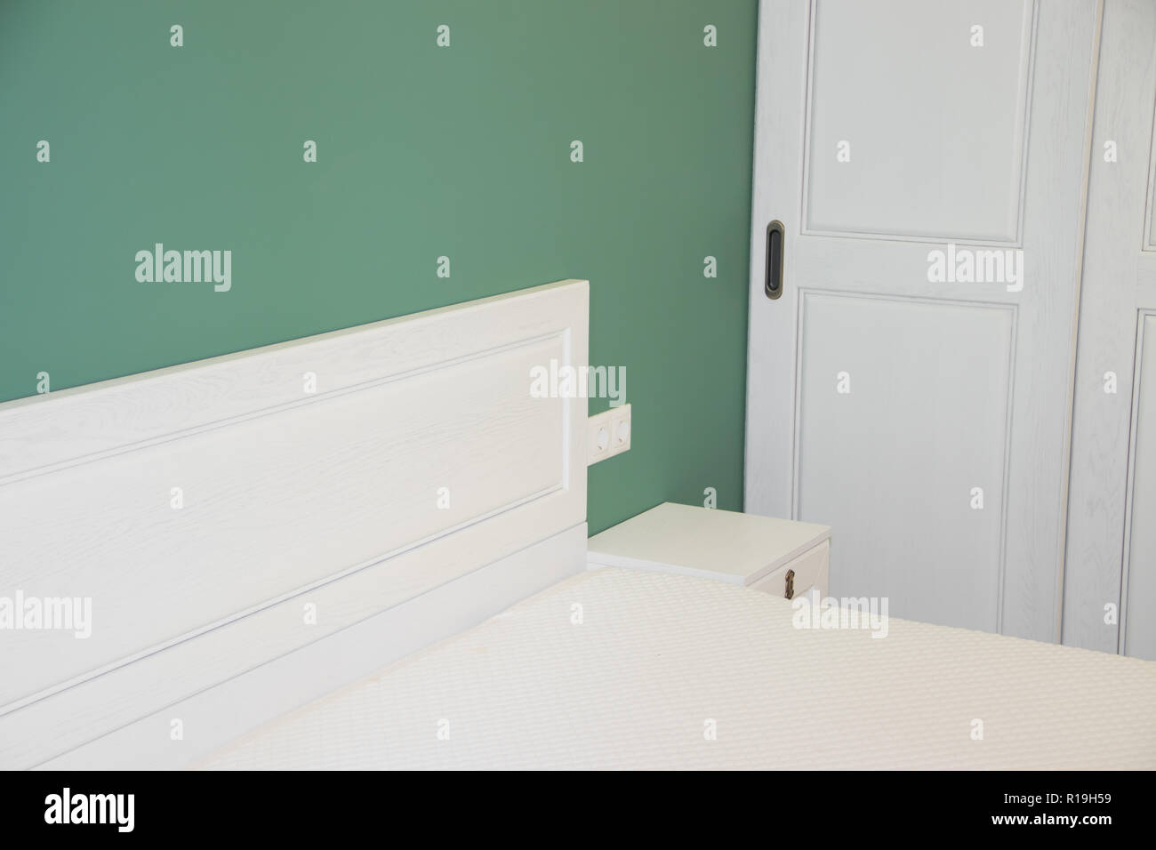 Large white bed in the bedroom. The interior of the bedroom. White ...