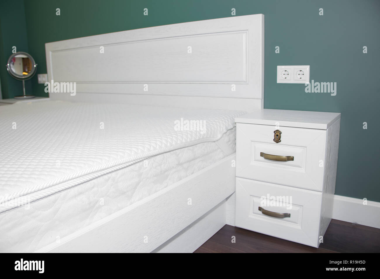 Large white bed in the bedroom. The interior of the bedroom. White ...