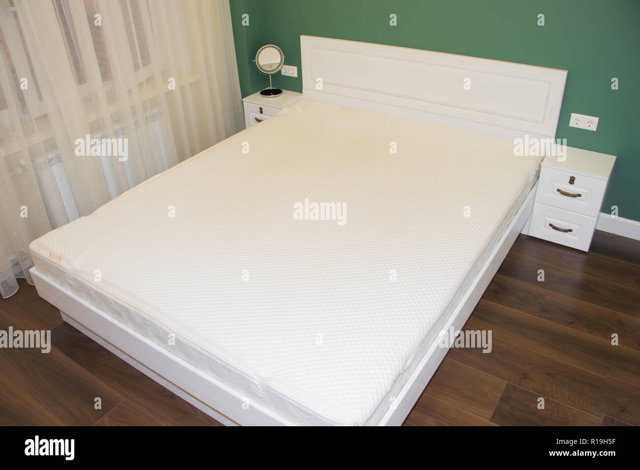 Large white bed in the bedroom. The interior of the bedroom. White ...