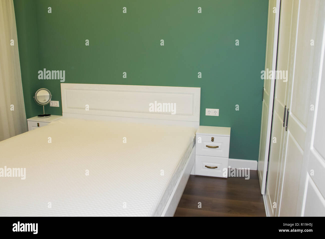 Large white bed in the bedroom. The interior of the bedroom. White ...
