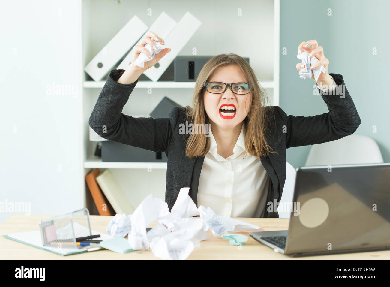 People, business and emotions concept - Angry woman sitting at desk in ...