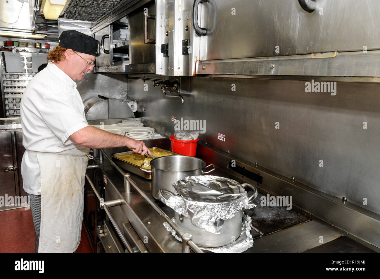 A chef prepares lunch in the kitchen onboard the Ghan train in ...