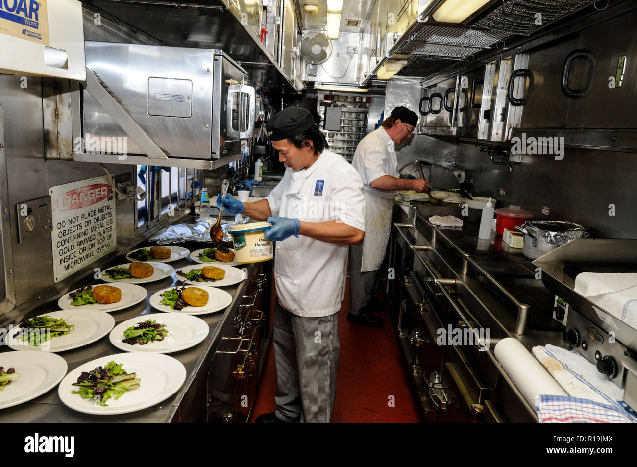 Two chefs preparing lunches in the kitchen onboard the Ghan train in ...