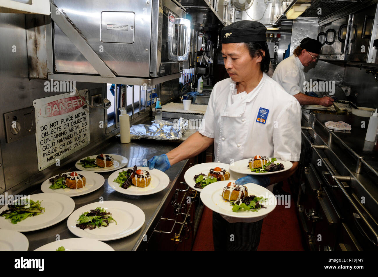 Two chefs preparing lunches in the kitchen onboard the Ghan train in ...