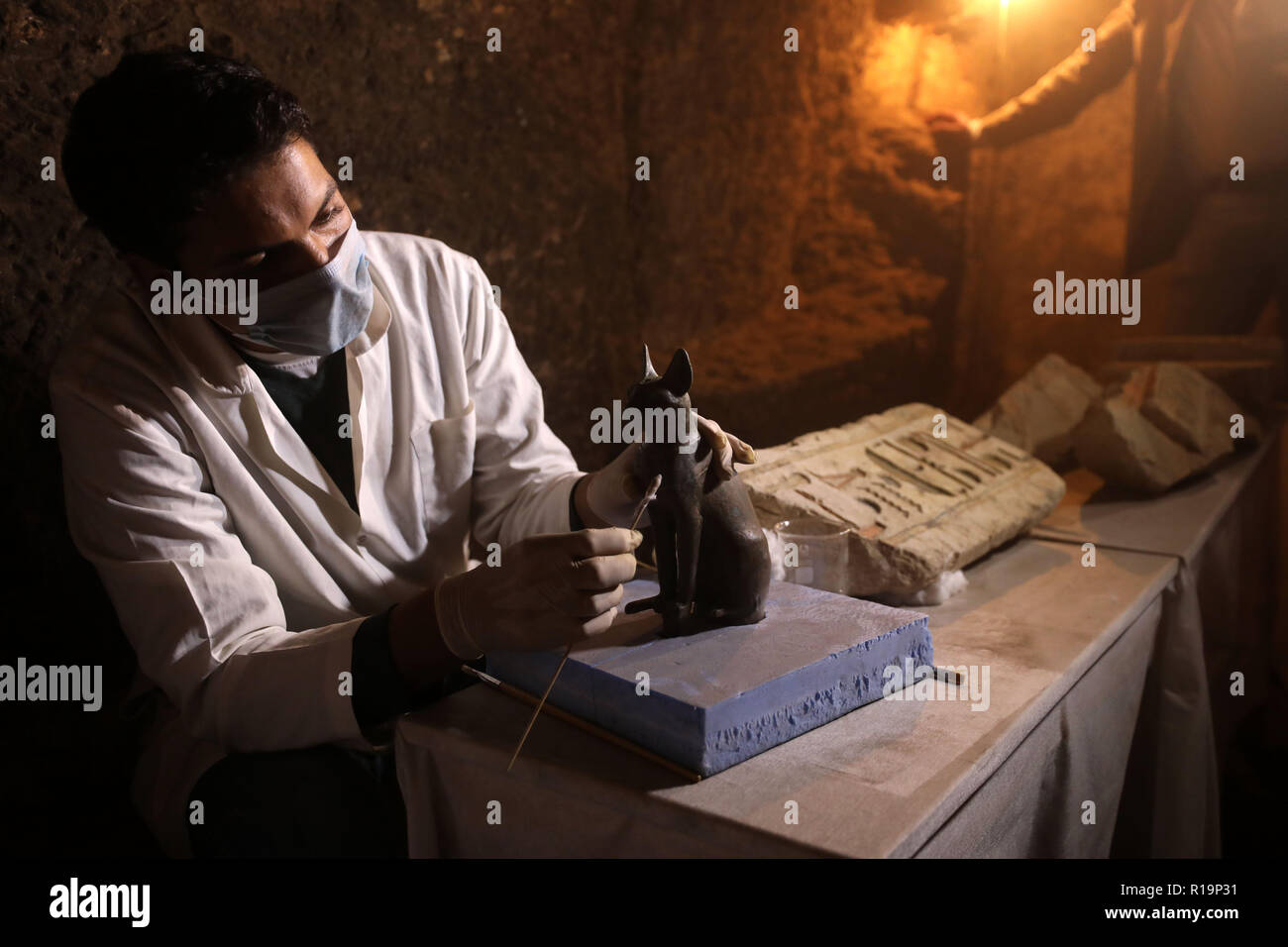 Giza, Egypt. 10th Nov, 2018. An Egyptian archaeologist works inside the ...