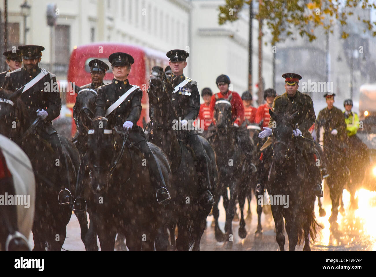 Riders of the British Army Royal Yeomanry getting caught in heavy rain ...