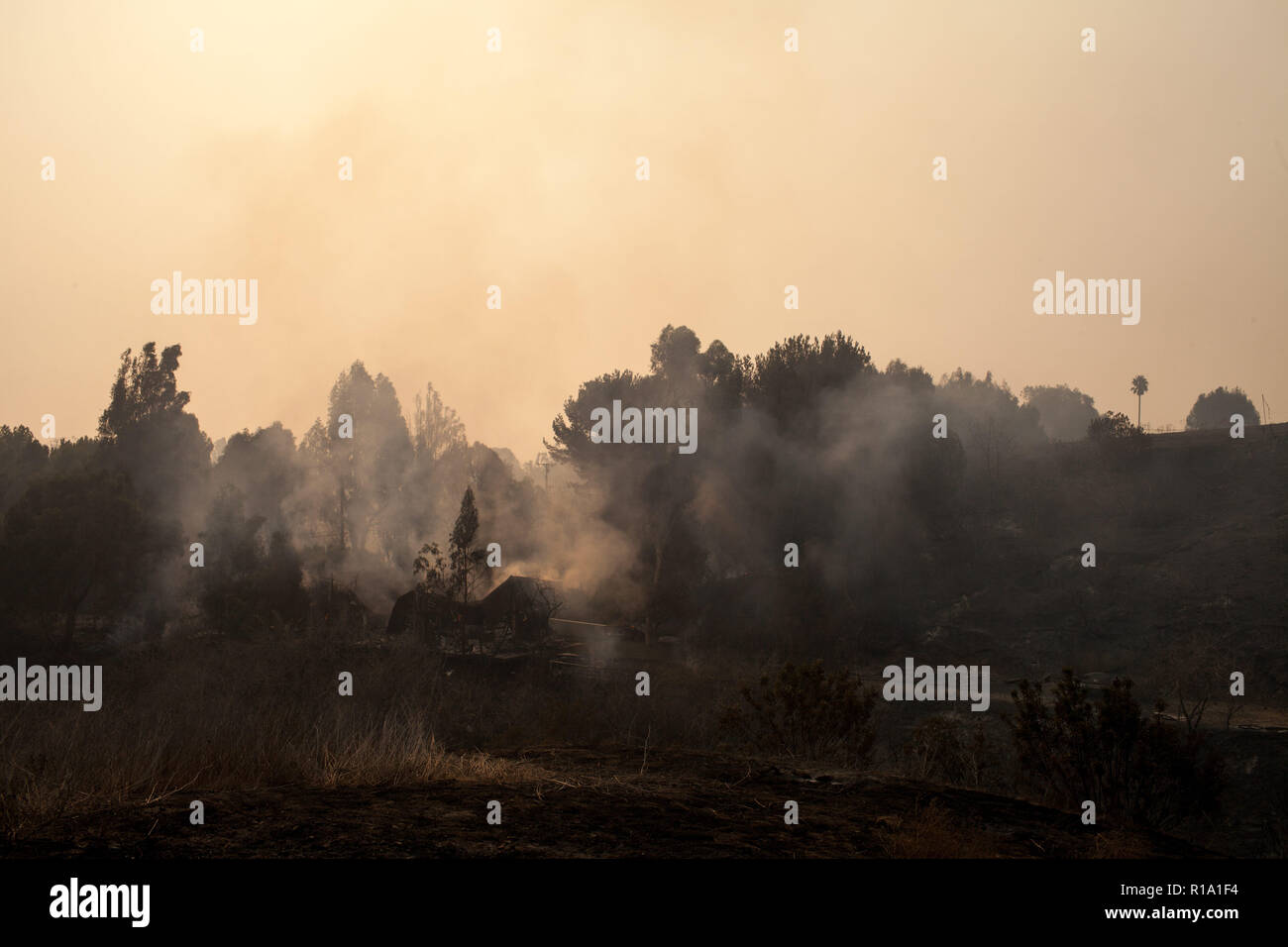 Malibu, California, USA. 10th Nov, 2018. A building burns along the ...