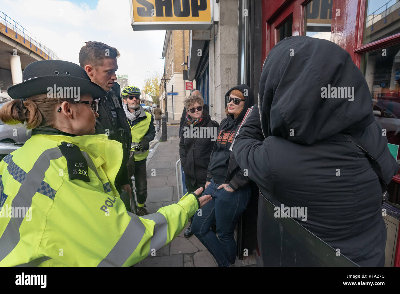 London, UK. 10th November 2018. Police officers talk to a small group ...