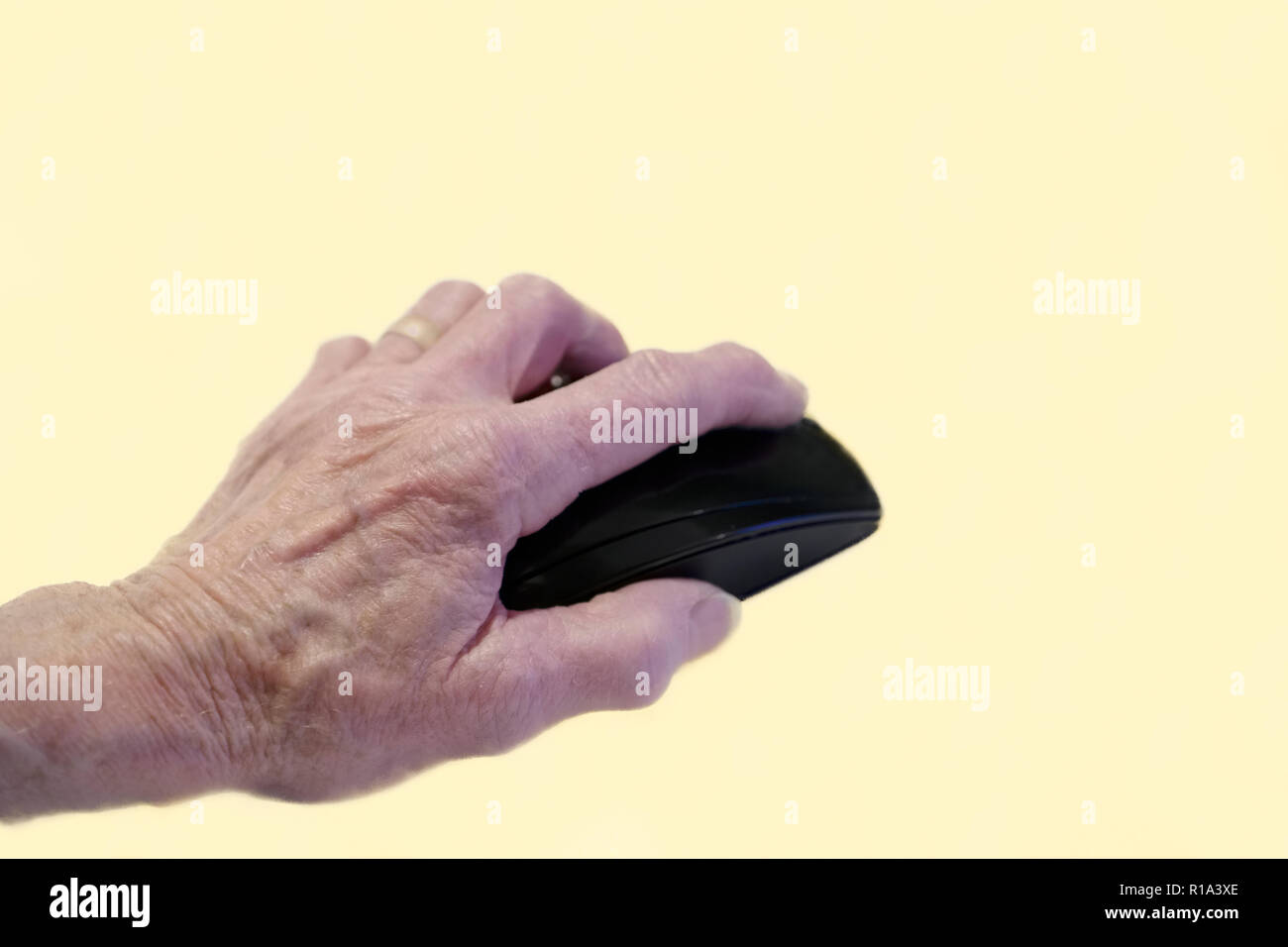 Elderly old senior hand holding wireless mouse learning computer ...