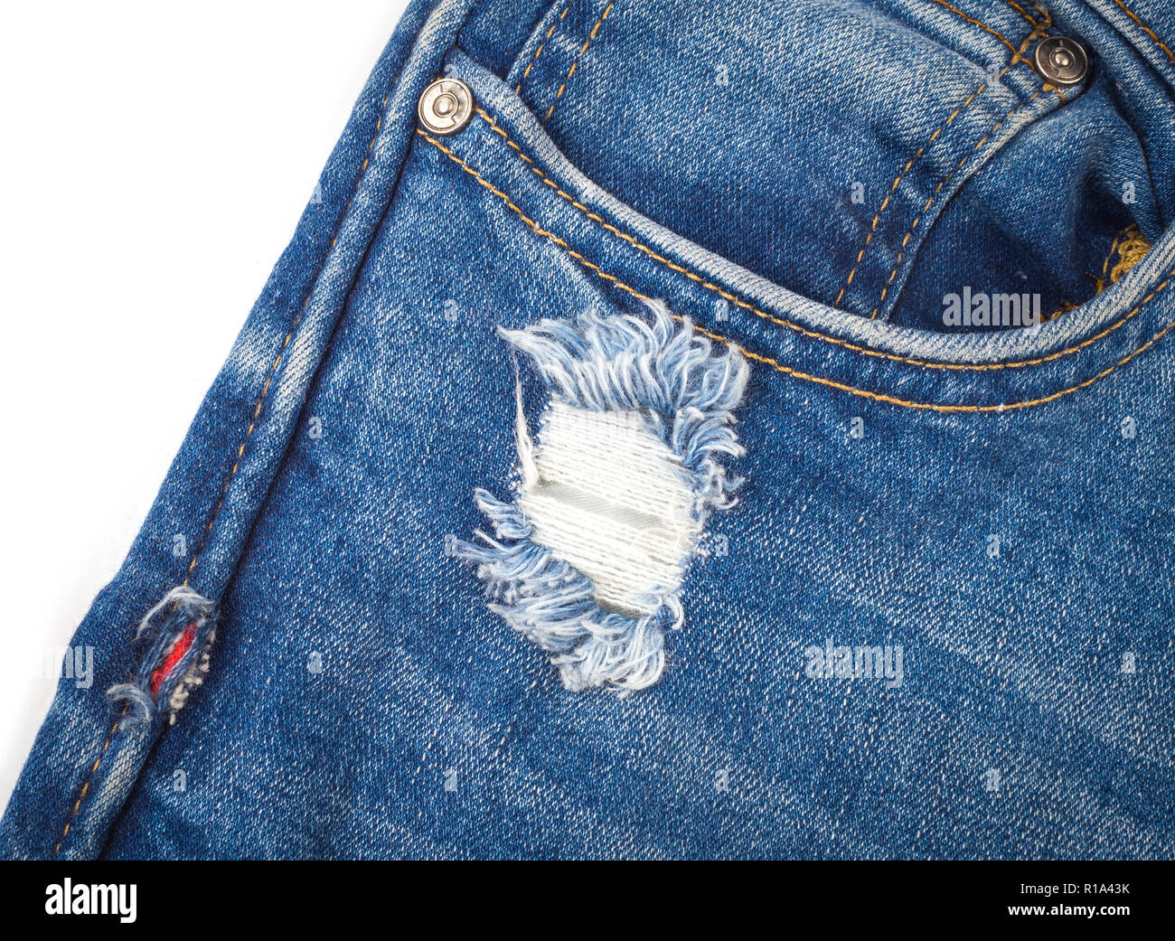 Textures ripped blue jeans on white background Stock Photo - Alamy
